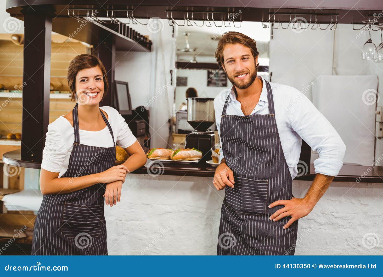 Happy Servers Smiling at Camera Stock Photo - Image of indoors, looking ...