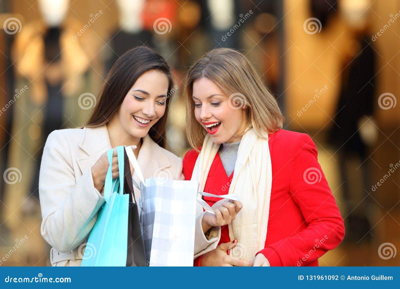 Happy Shoppers Checking Purchases in a Shooping Bag Stock Photo - Image ...
