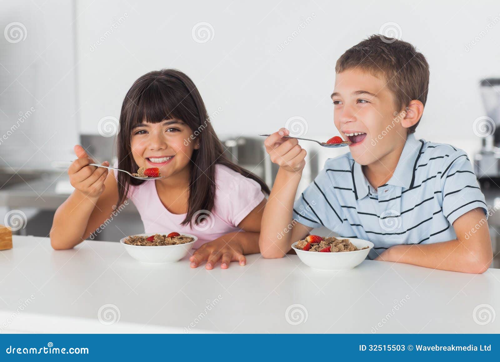 Happy Siblings Eating Cereal for Breakfast in Kitchen Stock Image ...