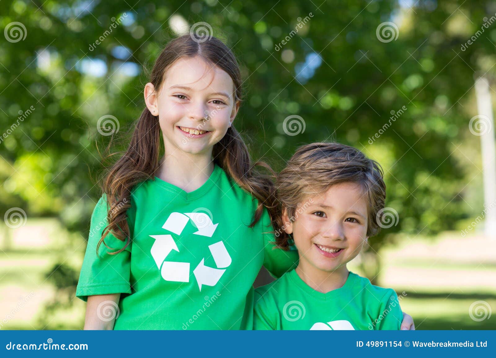 Happy Siblings in Green Smiling at the Camera Stock Photo - Image of ...