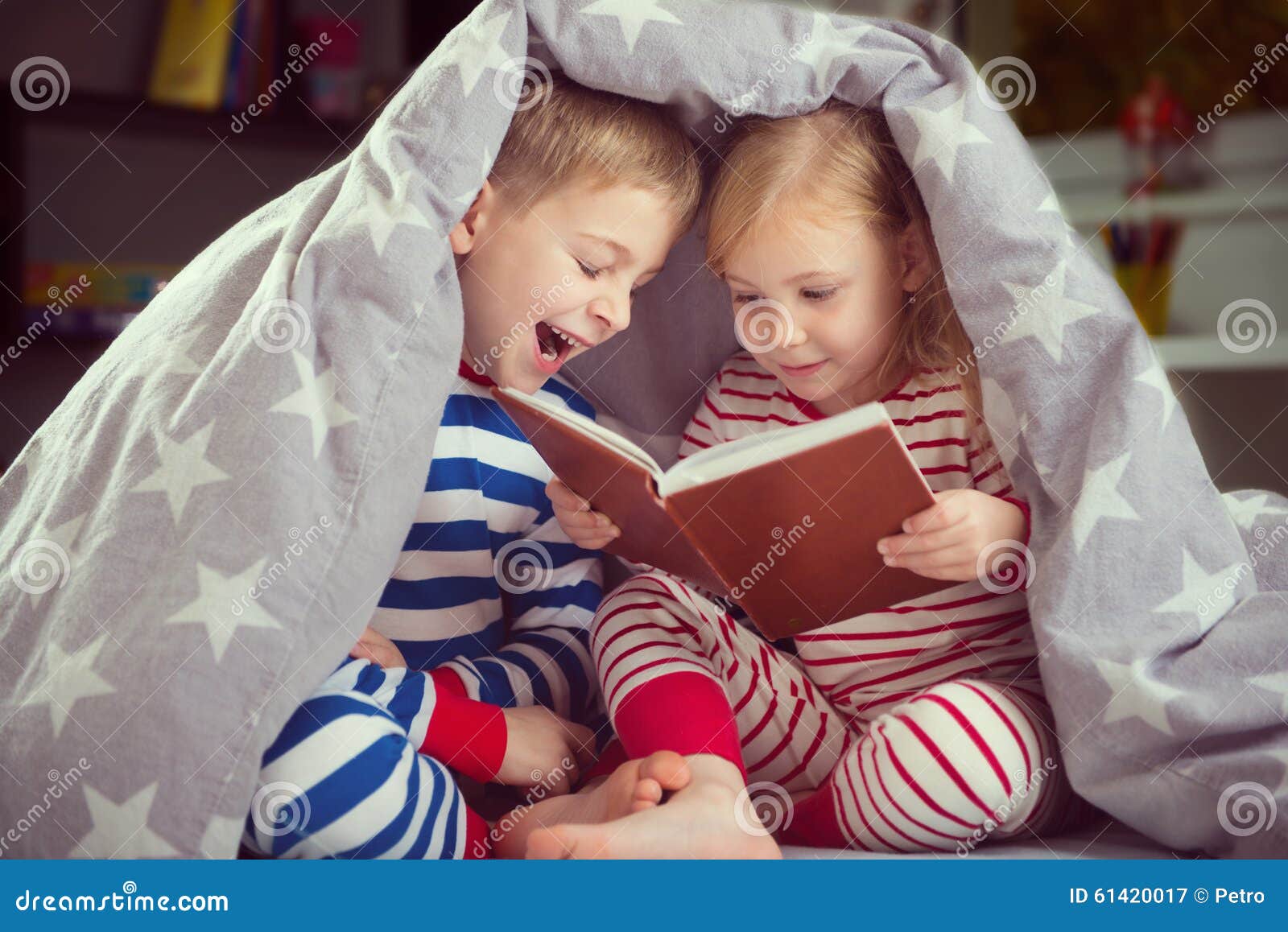 Happy Siblings Reading Book Under Cover Stock Image - Image of home ...