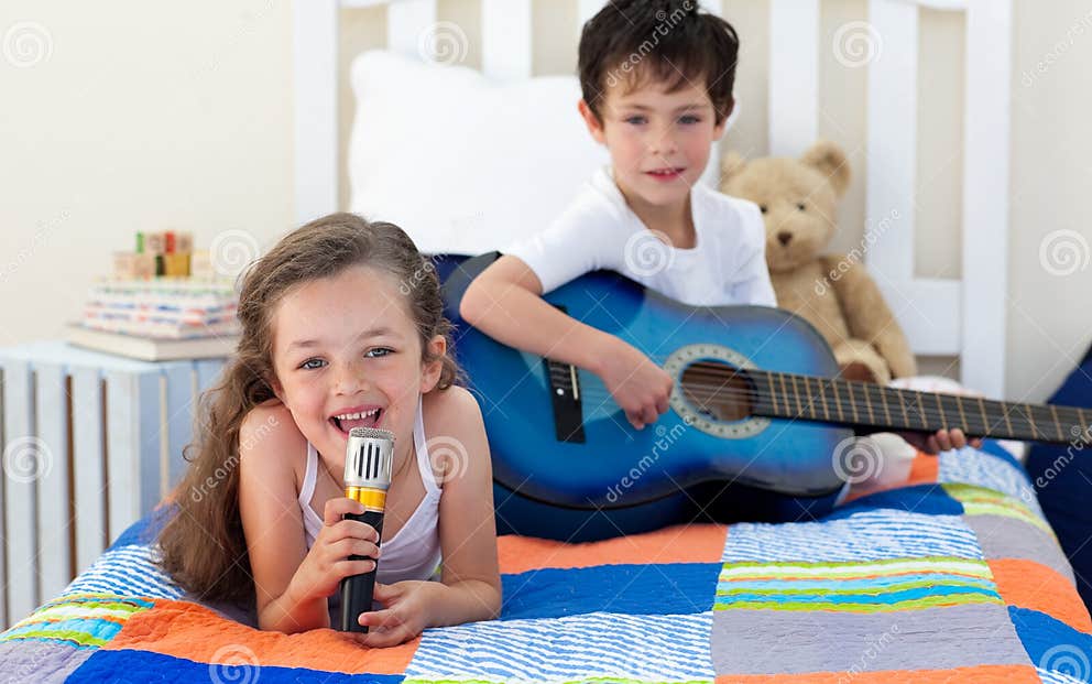 Happy Siblings Singing and Playing Guitar Stock Photo - Image of cute ...