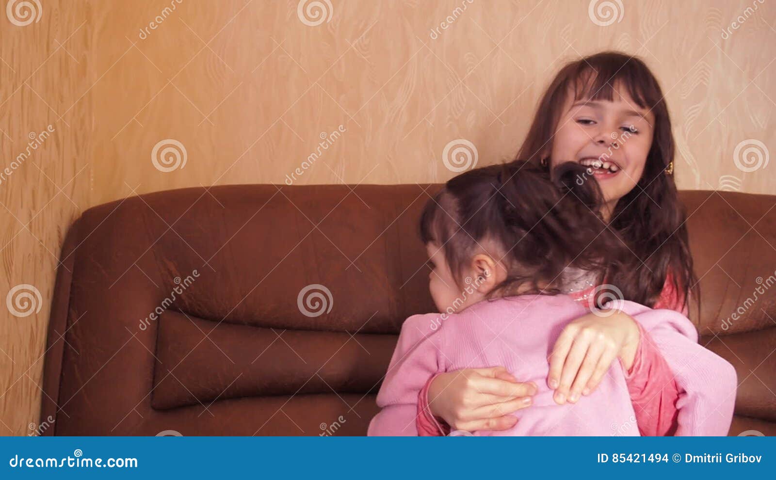 Happy sisters hug. stock footage. Video of child, background - 85421494