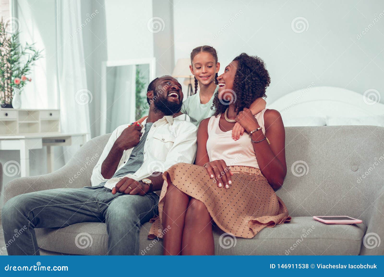Happy Smiling Afro-American Family of Three Sitting on the Sofa Stock ... Happy Smiling Afro-American Family of Three Sitting on the Sofa Stock ...