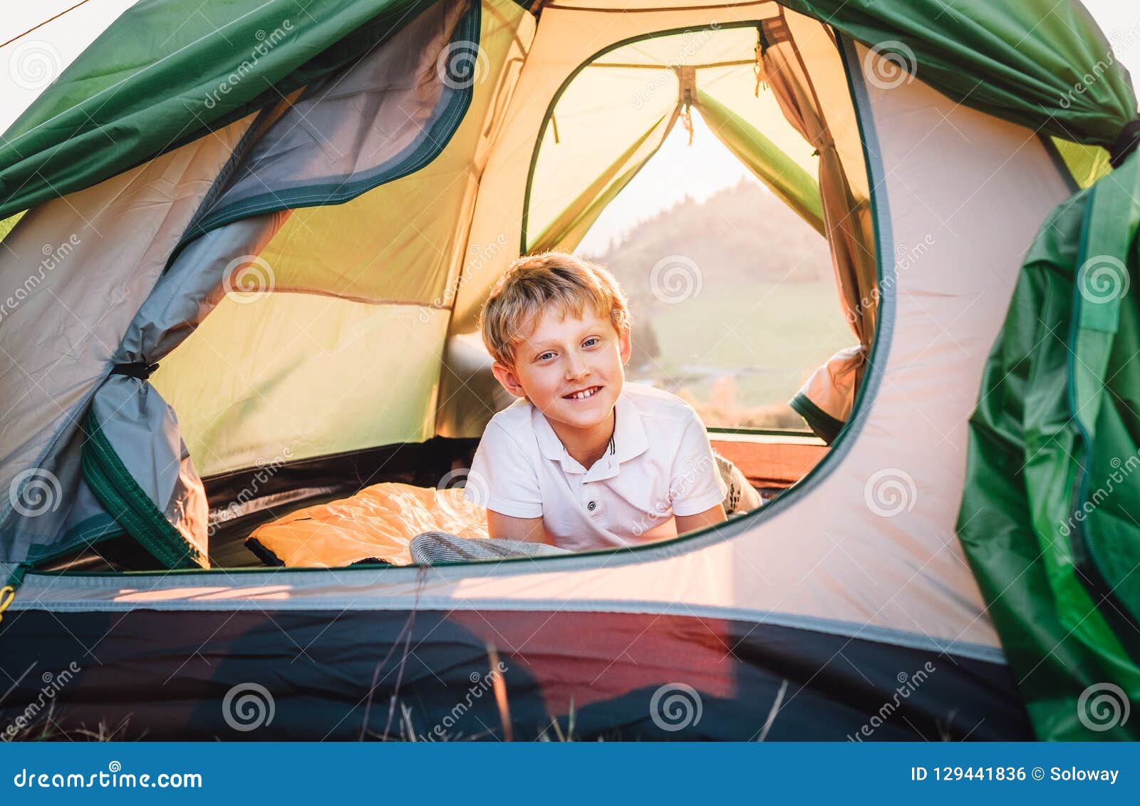 Happy Smiling Boy Rest in Tent at Sunset Time in Mountain Stock Photo ...
