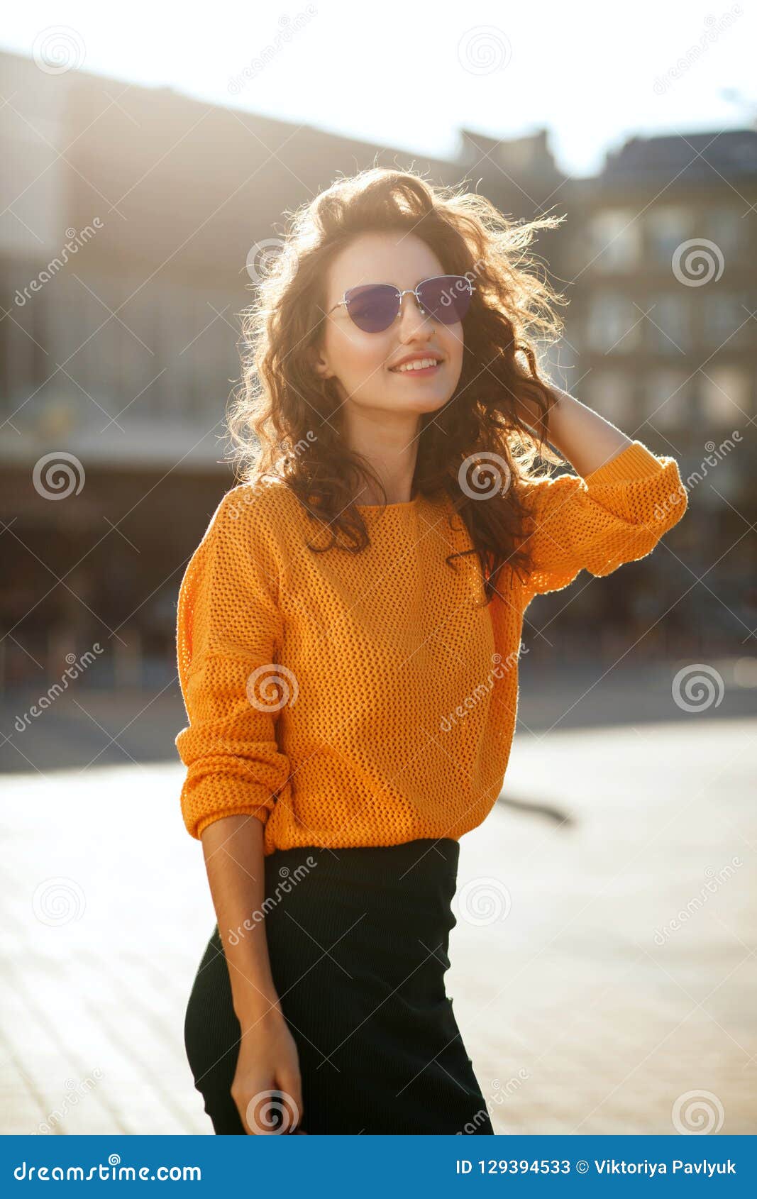 Happy Smiling Brunette Model With Curly Hair Wearing Glasses Posing In