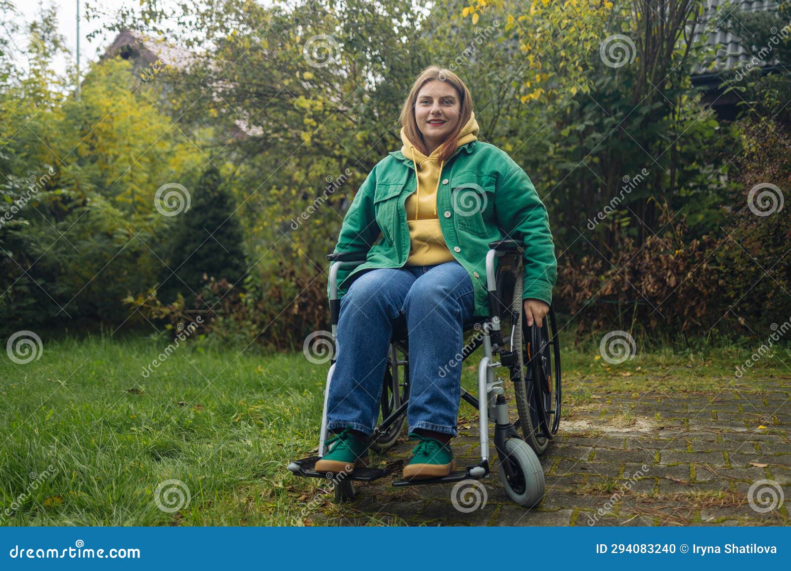 Happy Smiling Cheerful Caucasian Girl On A Wheelchair Relaxing Alone In