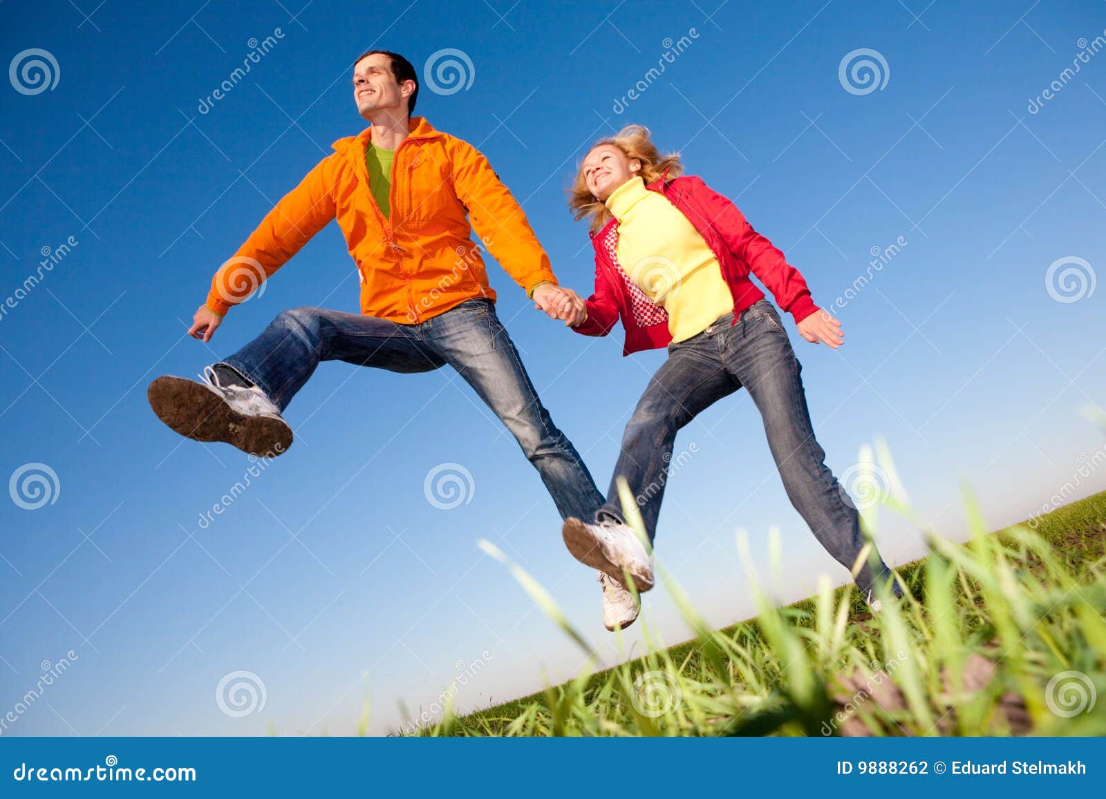 Happy Smiling Couple Jumping in Blu Sky Stock Photo - Image of clothing ...