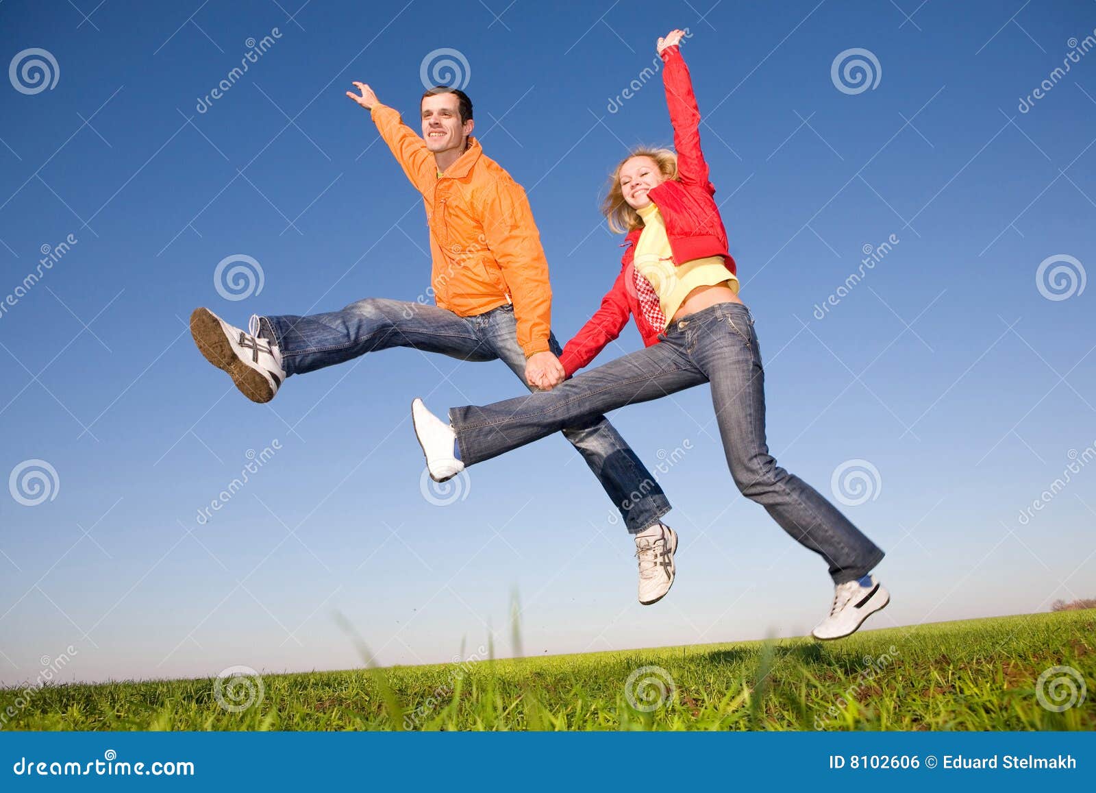 Happy Smiling Couple Jumping in Blue Sky Stock Photo - Image of ...