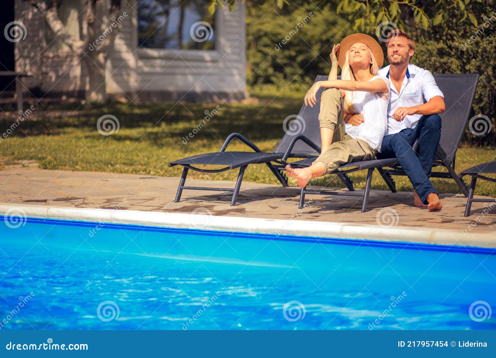 Happy Smiling Couple Sitting by the Pool Stock Photo - Image of ...