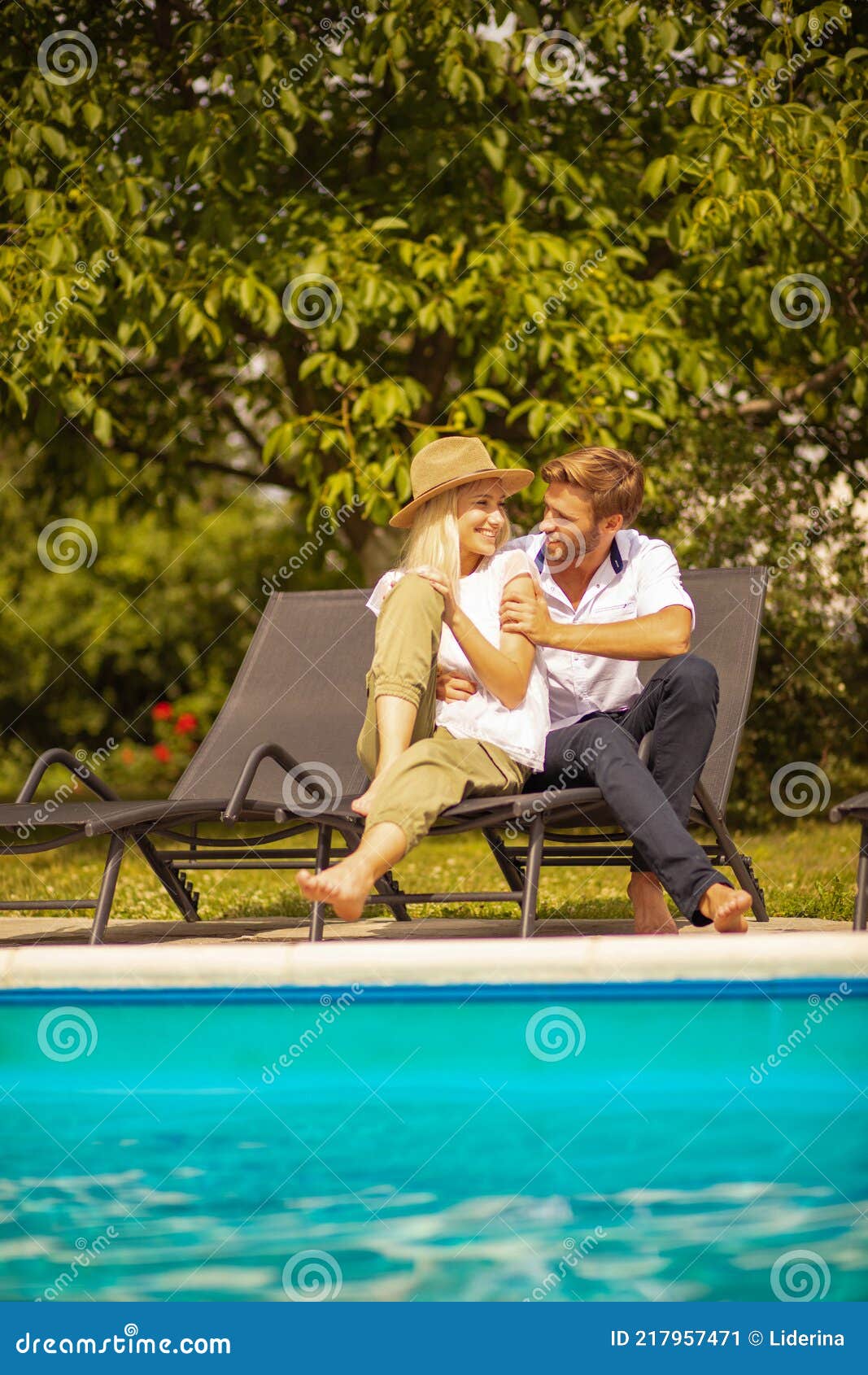 Smiling Couple Sitting by the Pool Stock Image - Image of activity ...