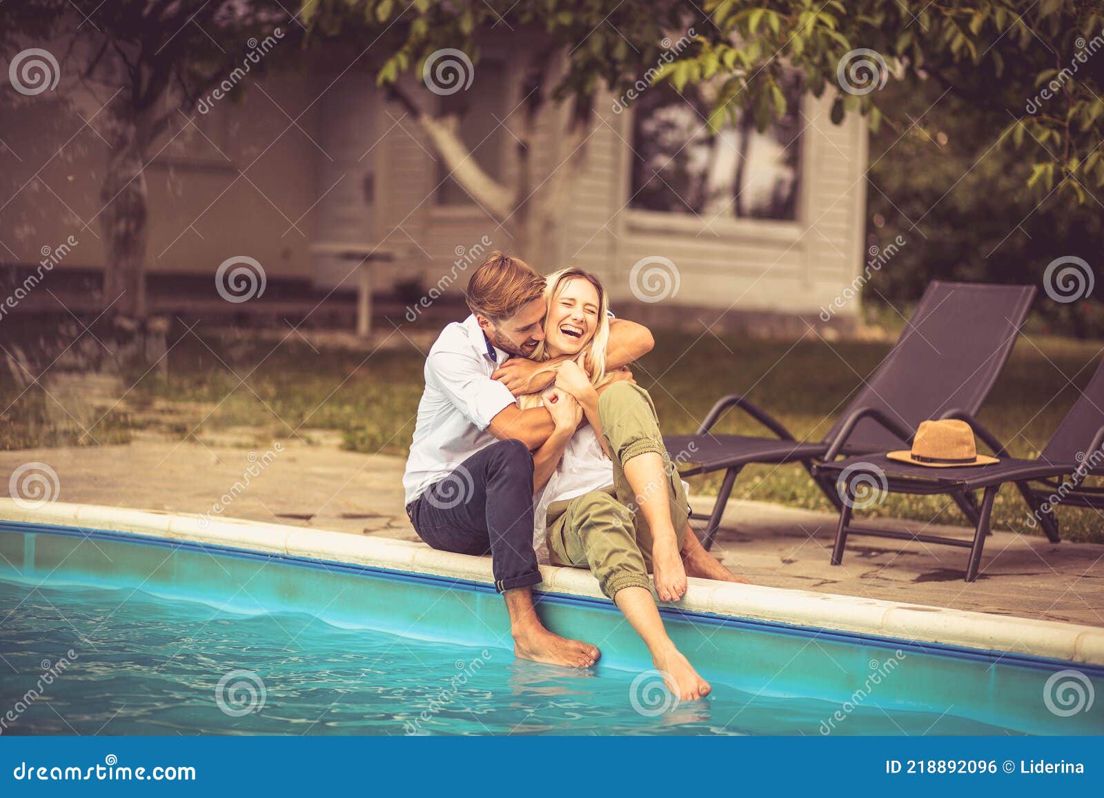 Smiling Couple Sitting by the Pool Stock Photo - Image of sitting ...