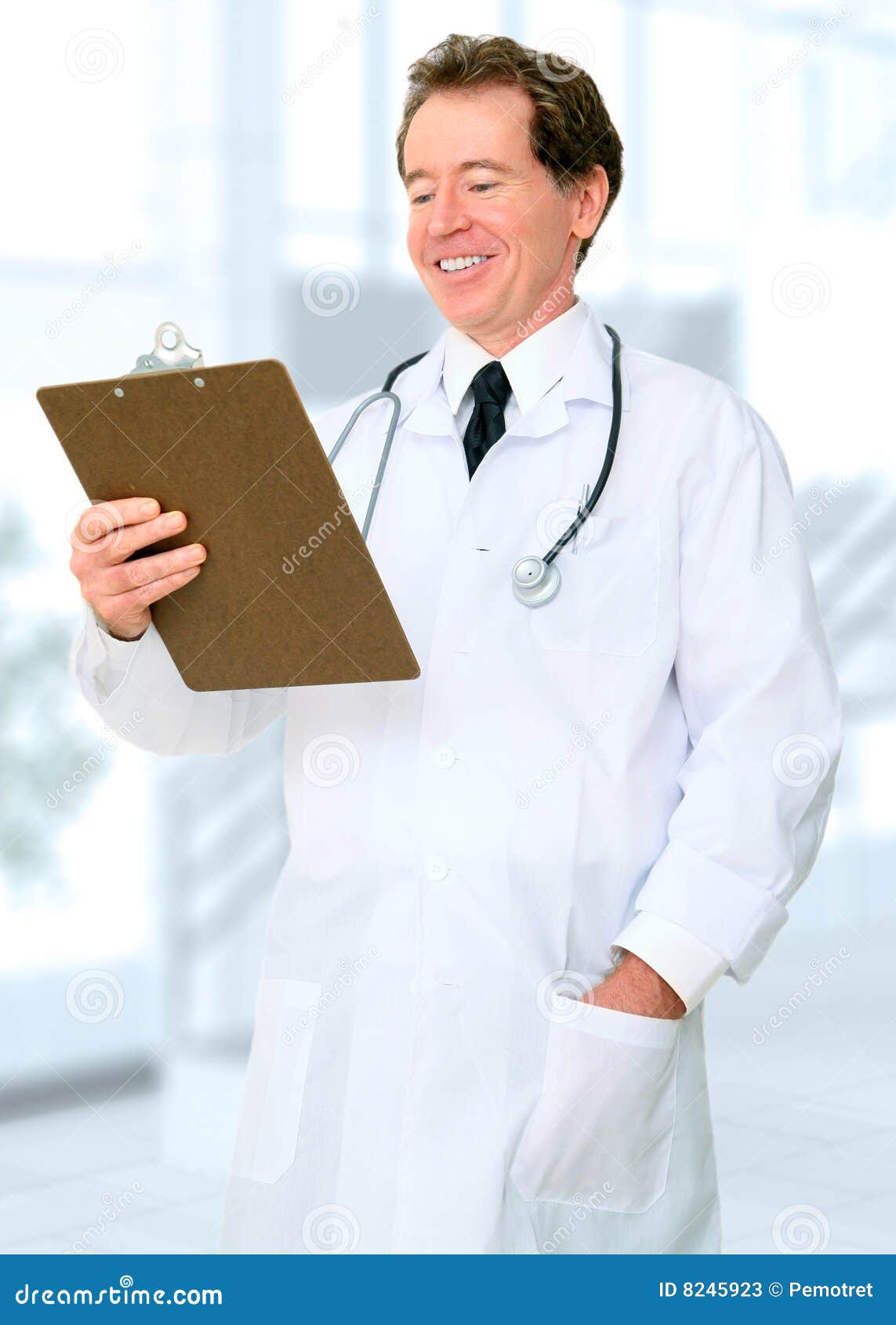 Happy Smiling Doctor Reading Report in His Office Stock Image - Image ...