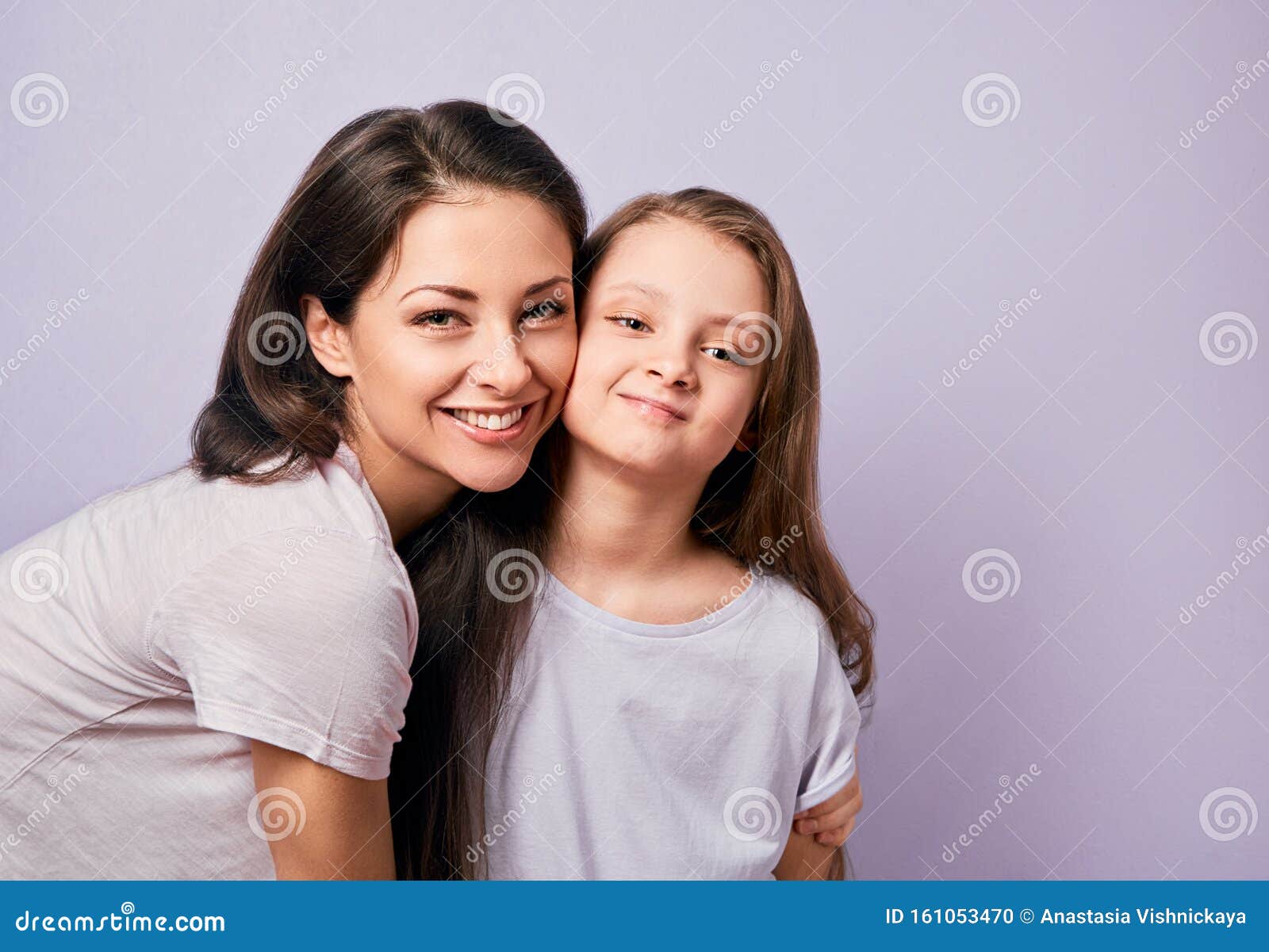 Happy Smiling Emotion Mother Cuddling Her Cute Daughter With Love On