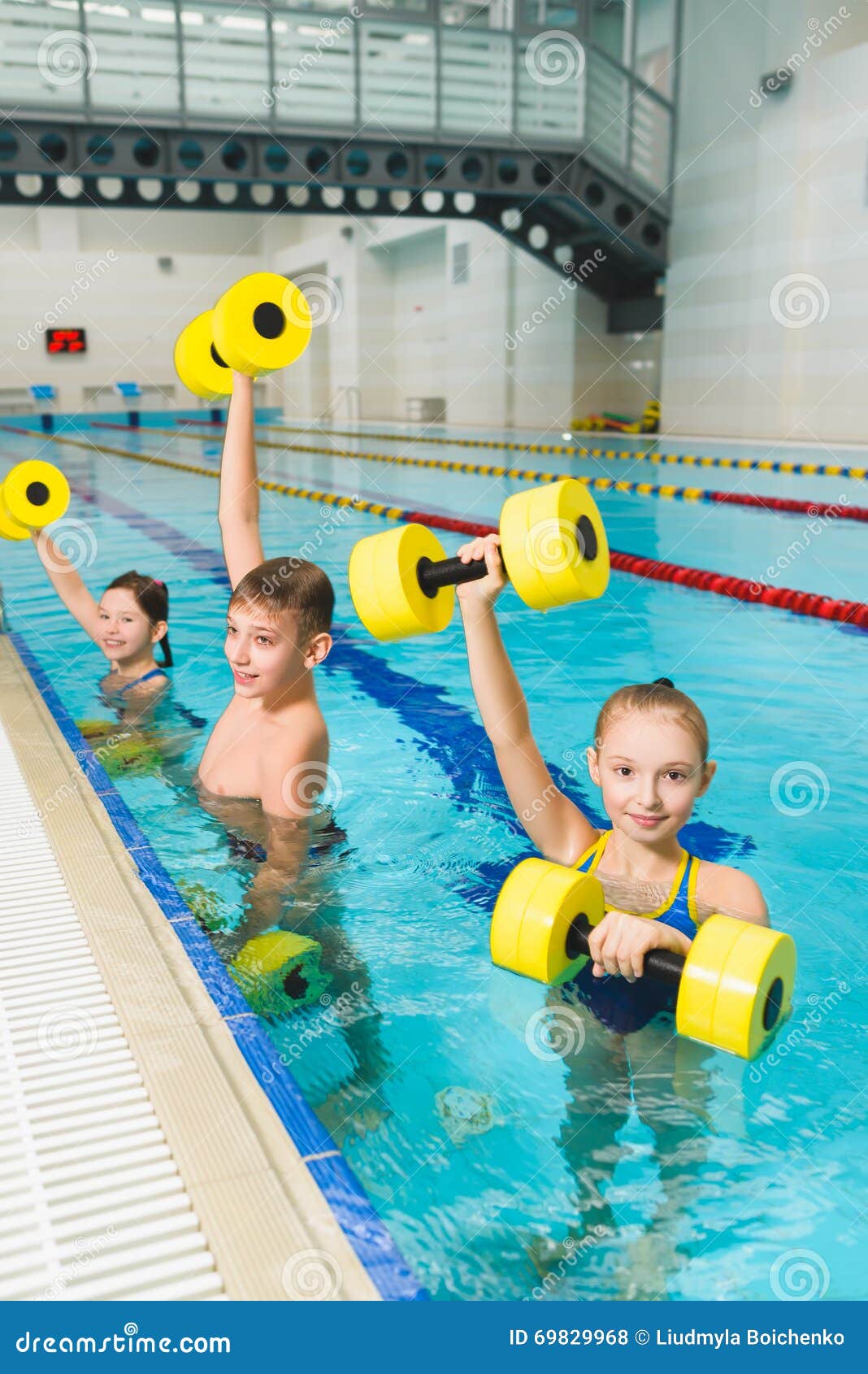 Happy and Smiling Group of Children Doing Exercises in a Swimming Pool ...
