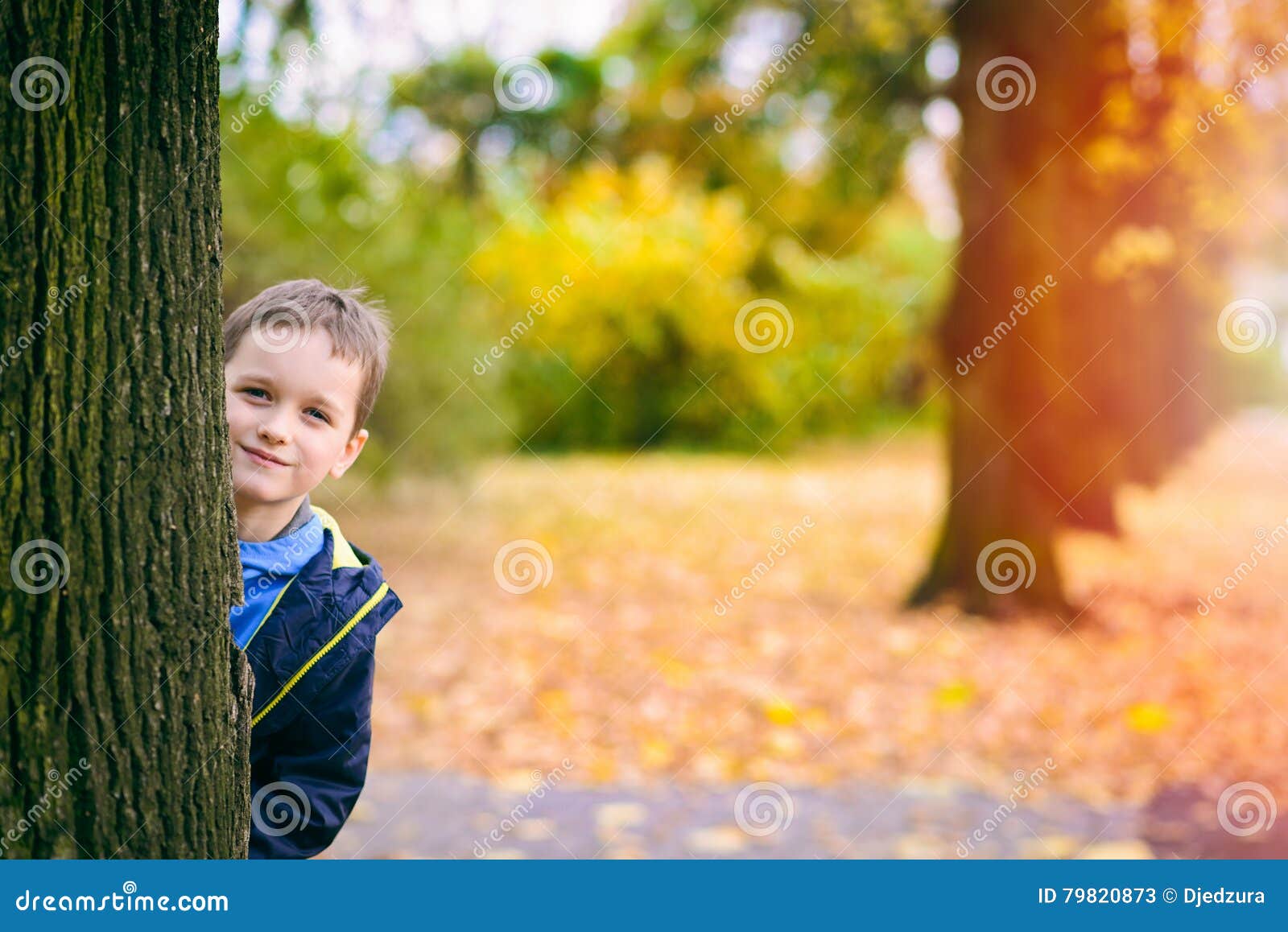 Happy Smiling Hiding Behind Tree Stock Image - Image of copy, play ...