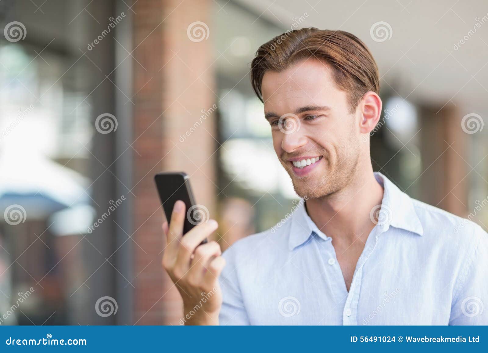 A Happy Smiling Man Looking at the Phone Stock Photo - Image of phone ...
