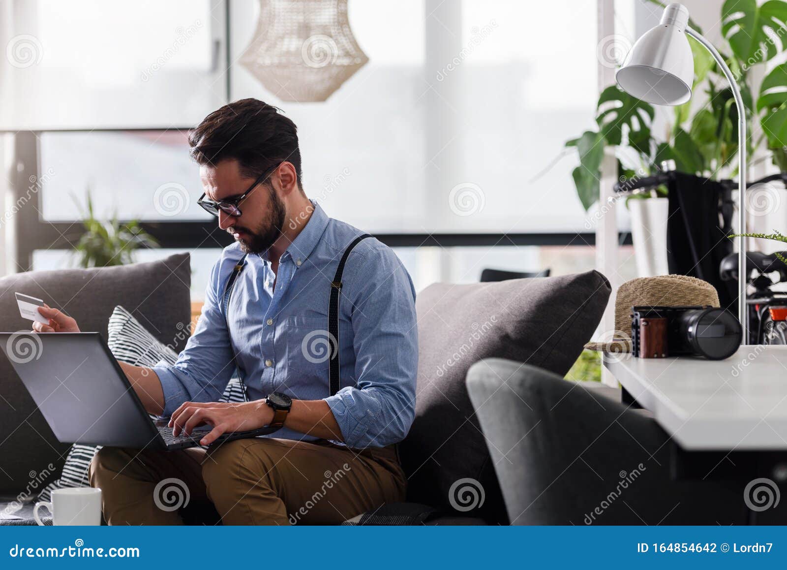 Happy Smiling Man Using Debit Card Working on Laptop Computer while ...
