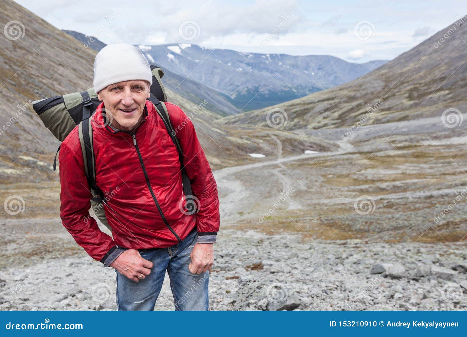 Happy and Smiling Mature Backpacker Looking at Camera while Hiking in ...