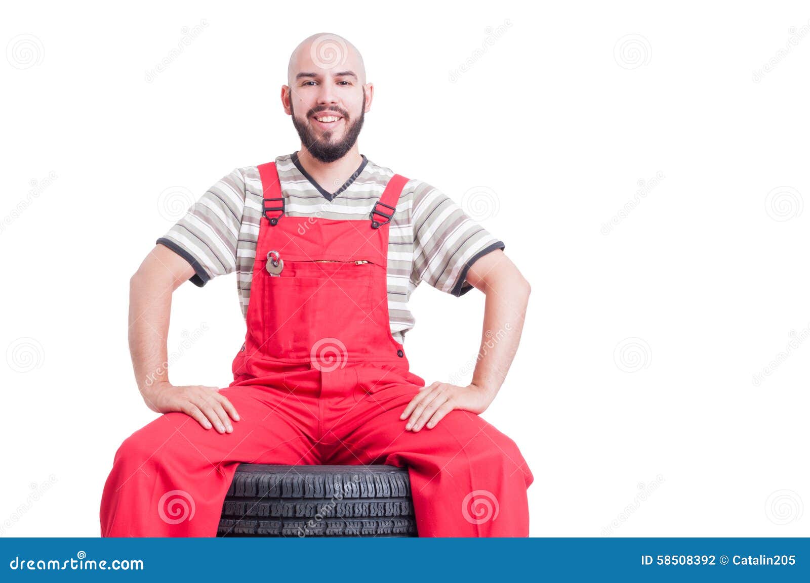 Happy Smiling Mechanic Sitting on Stack of Car Wheels Stock Photo ...