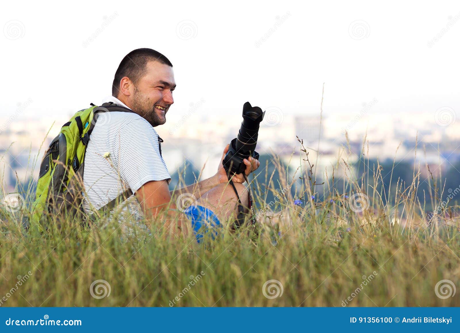 Happy Smiling Photographer Sitting in Grass in Summer with a Cam Stock ...
