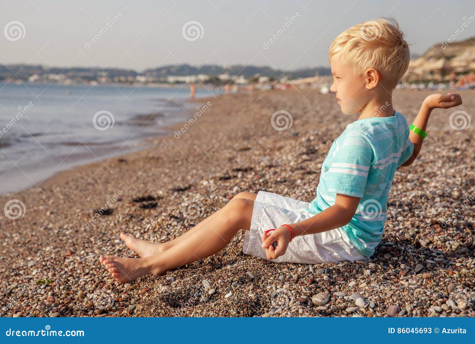 Happy Smiling Small Boy Sitting on the Beach and Playing with Stones ...