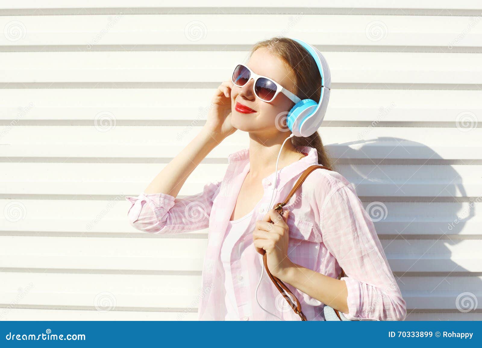 Happy Smiling Woman Listens To Music In Headphones Over White Stock