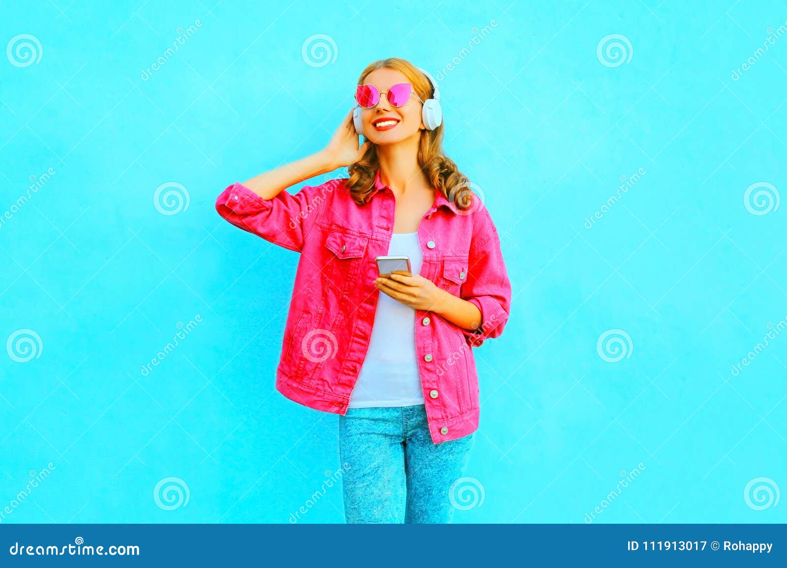 Happy Smiling Woman Listens To Music In A Wireless Headphones With