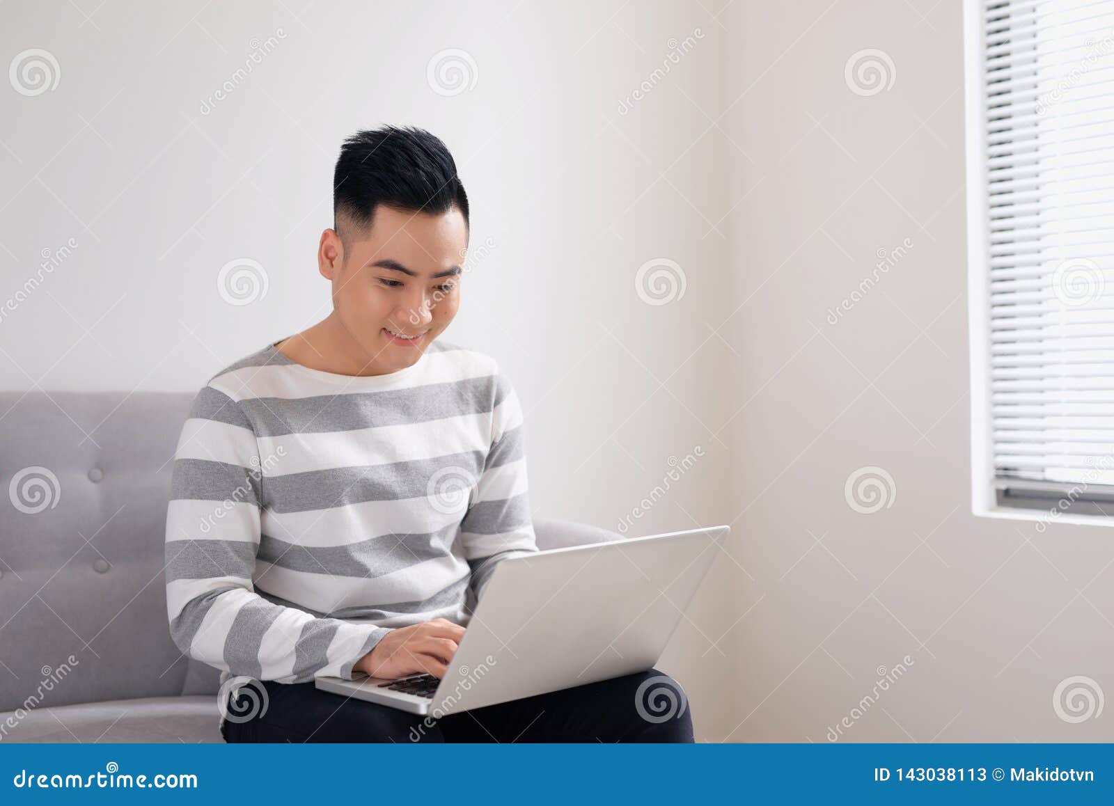 Happy Smiling Young Man Watching and Working on Computer Laptop at Home ...