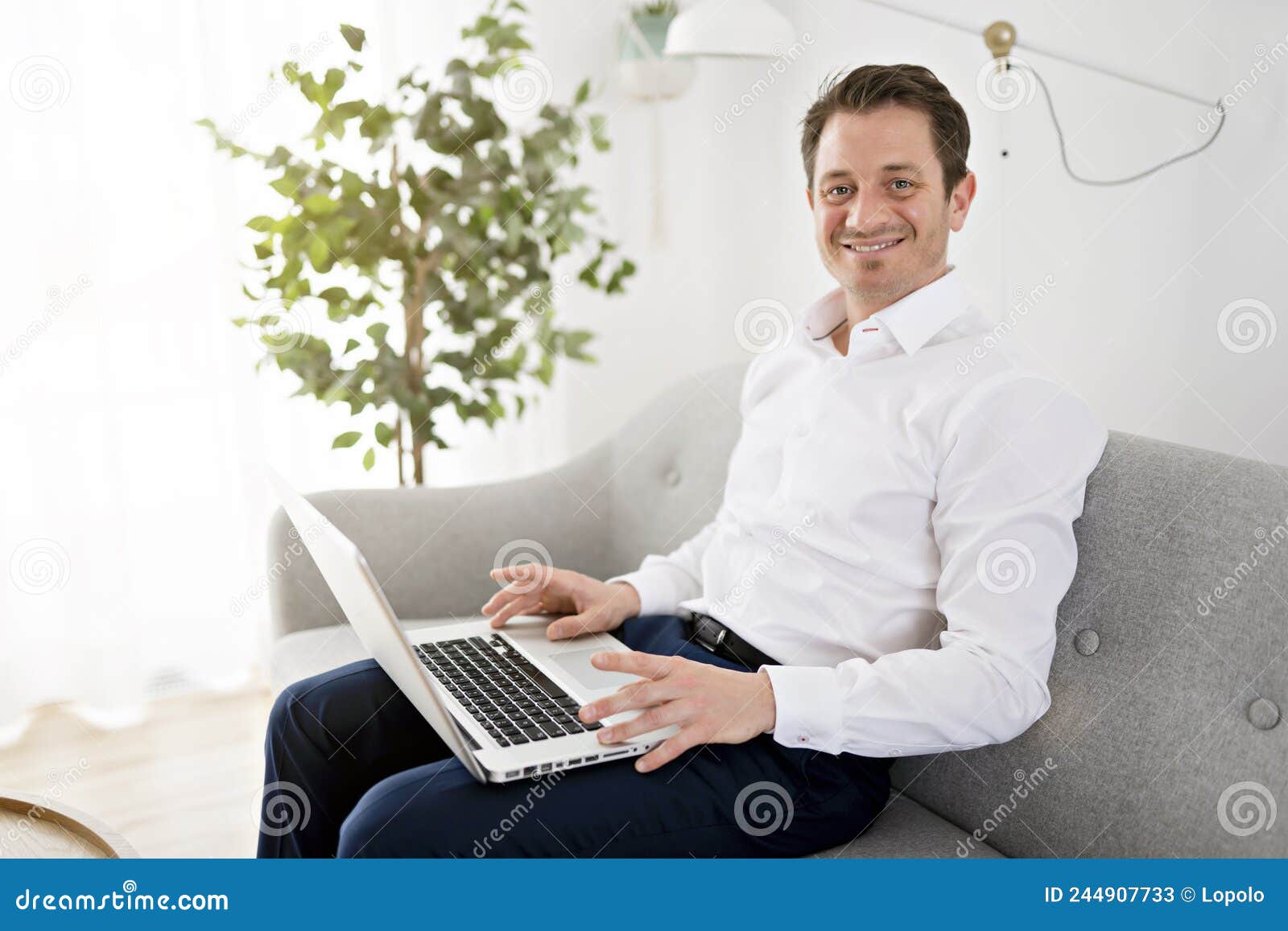 Happy Smiling Young Man Watching and Working on Computer Laptop at Home ...