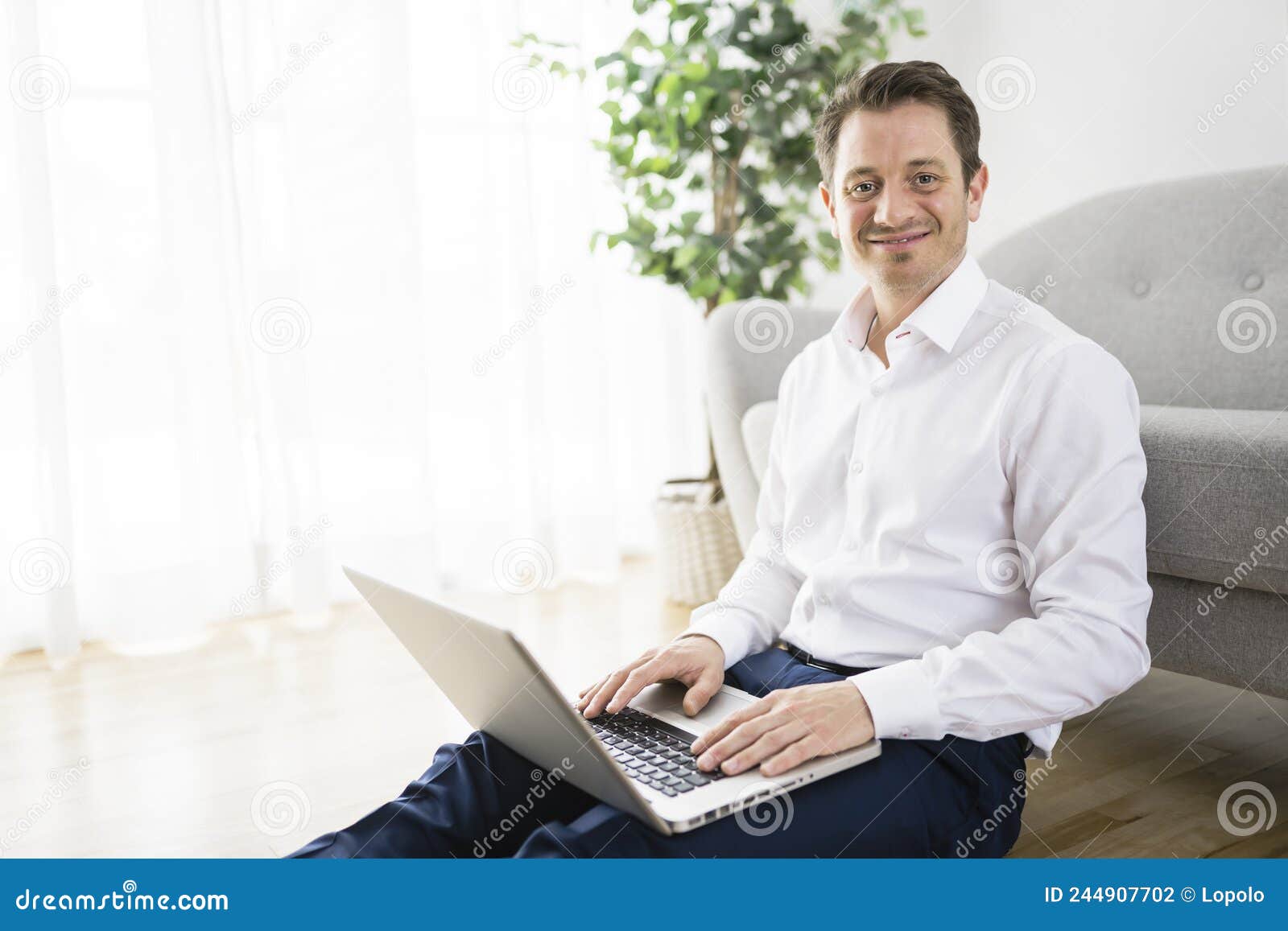 Happy Smiling Young Man Watching and Working on Computer Laptop at Home ...