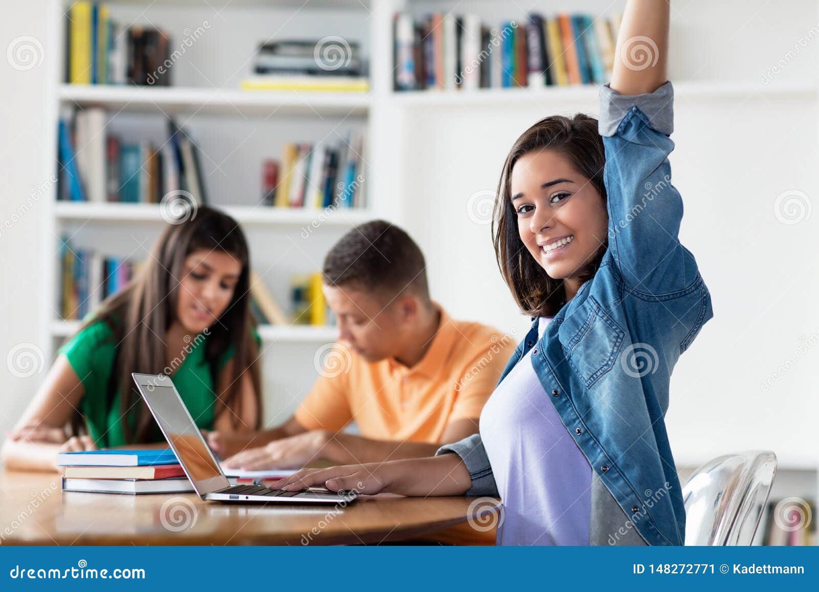 Happy Spanish Female Student with Group of Learning Students Stock ...