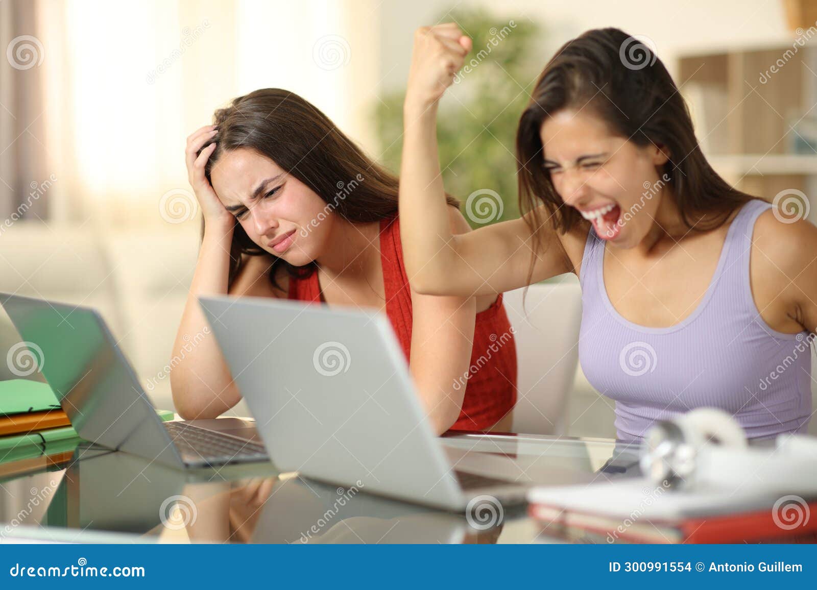Happy Student Celebrating Grades beside a Sad One Stock Photo - Image ...