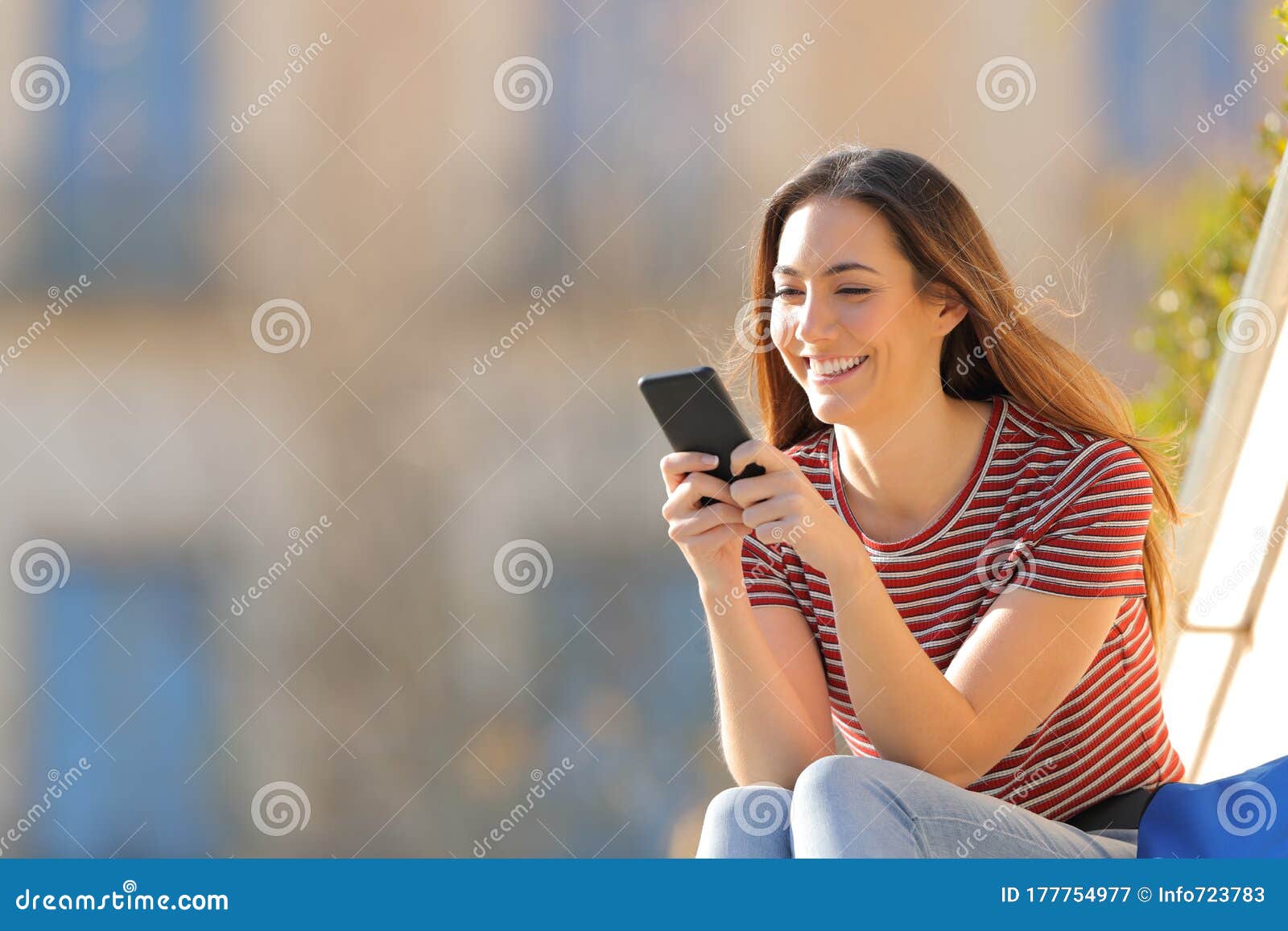 Happy Student Checking Mobile Phone in a Campus Stock Image - Image of ...