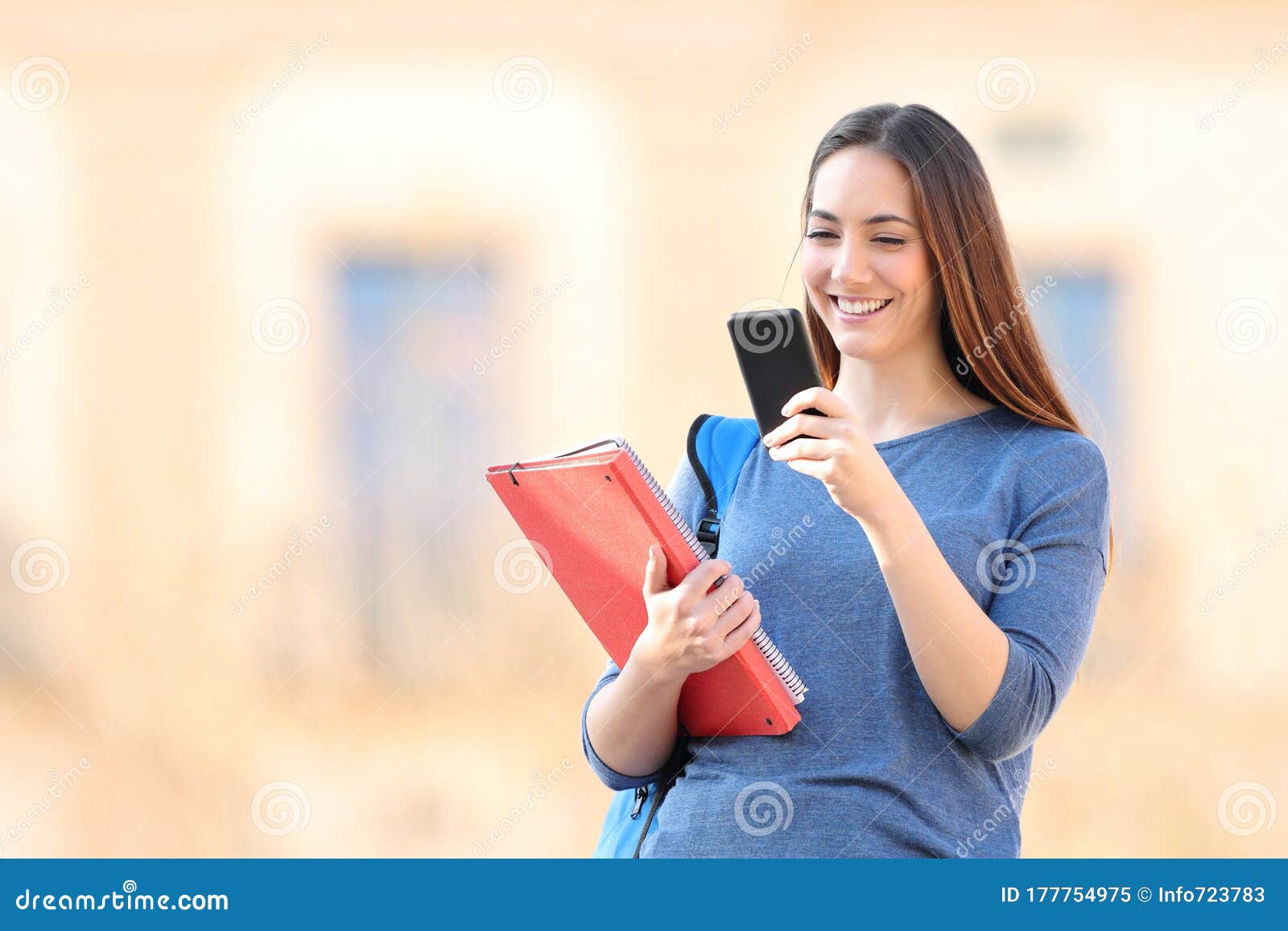 Happy Student Checking Mobile Phone Standing in a Campus Stock Image ...