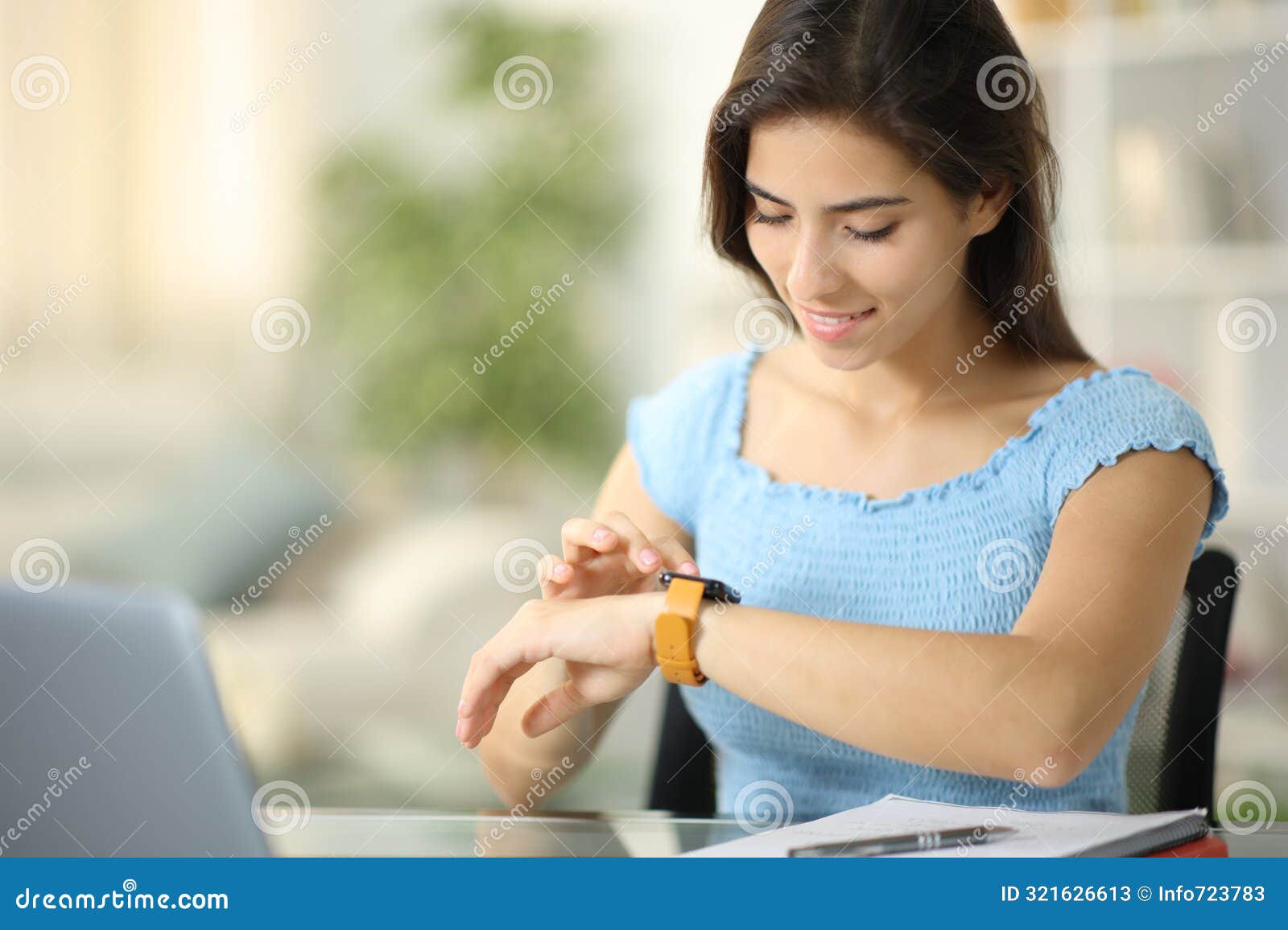 Happy Student Checking Smartwatch in a House Interior Stock Image ...