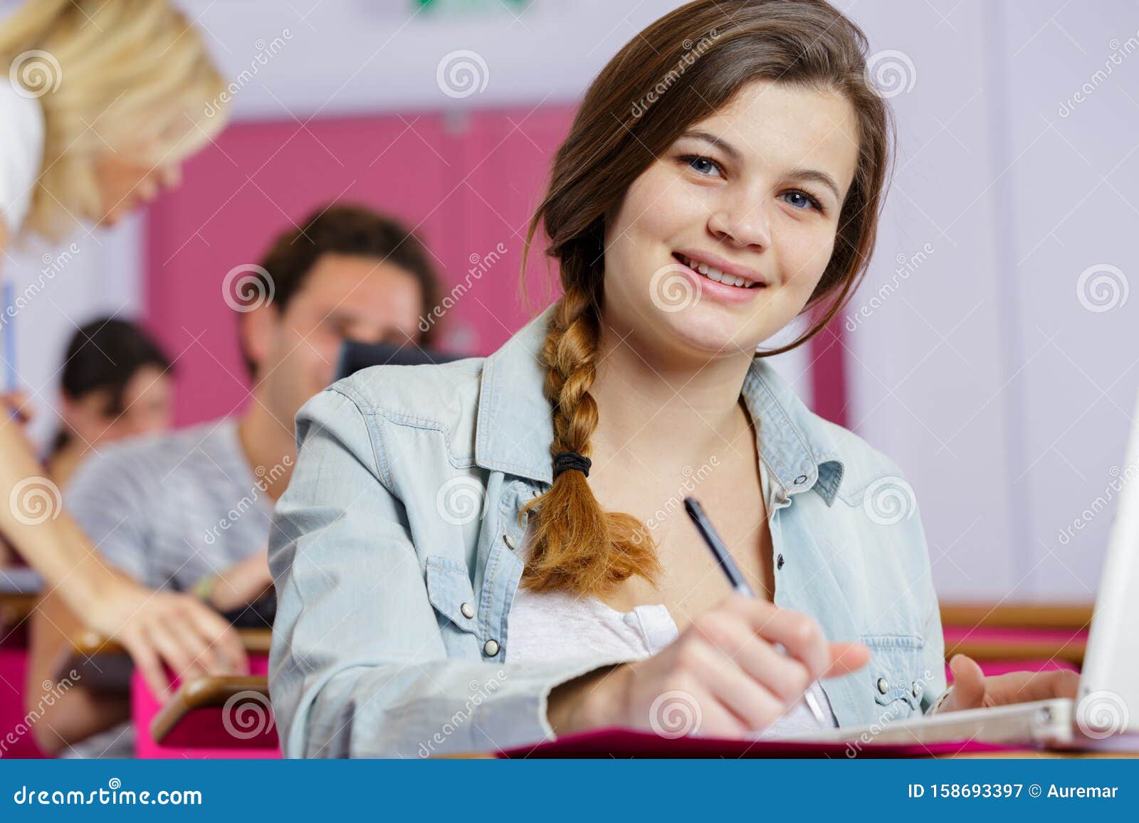 Happy student in classroom stock image. Image of learning - 158693397