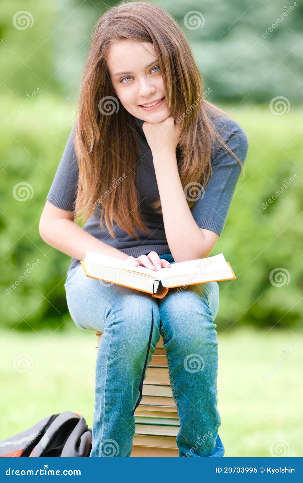 Happy Student Girl Sitting on Pile of Books Stock Photo - Image of ...