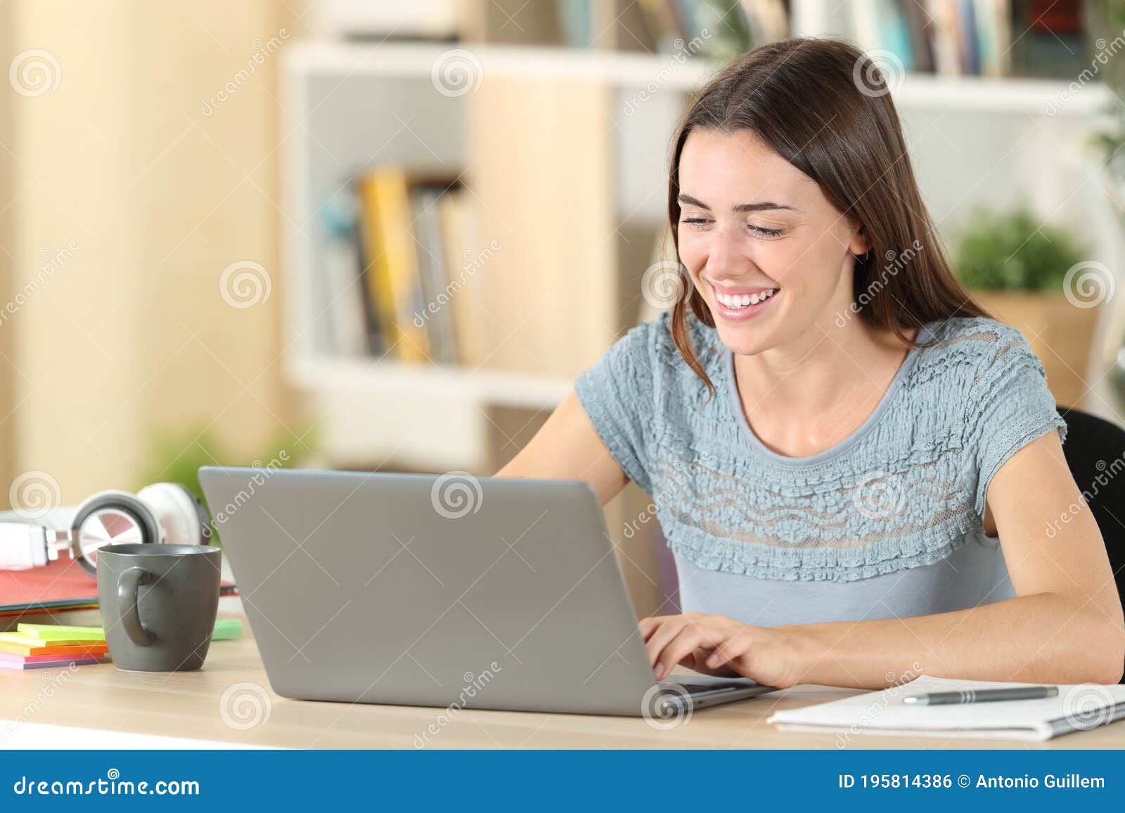 Happy Student Laughing Using Laptop on a Desk at Home Stock Photo ...