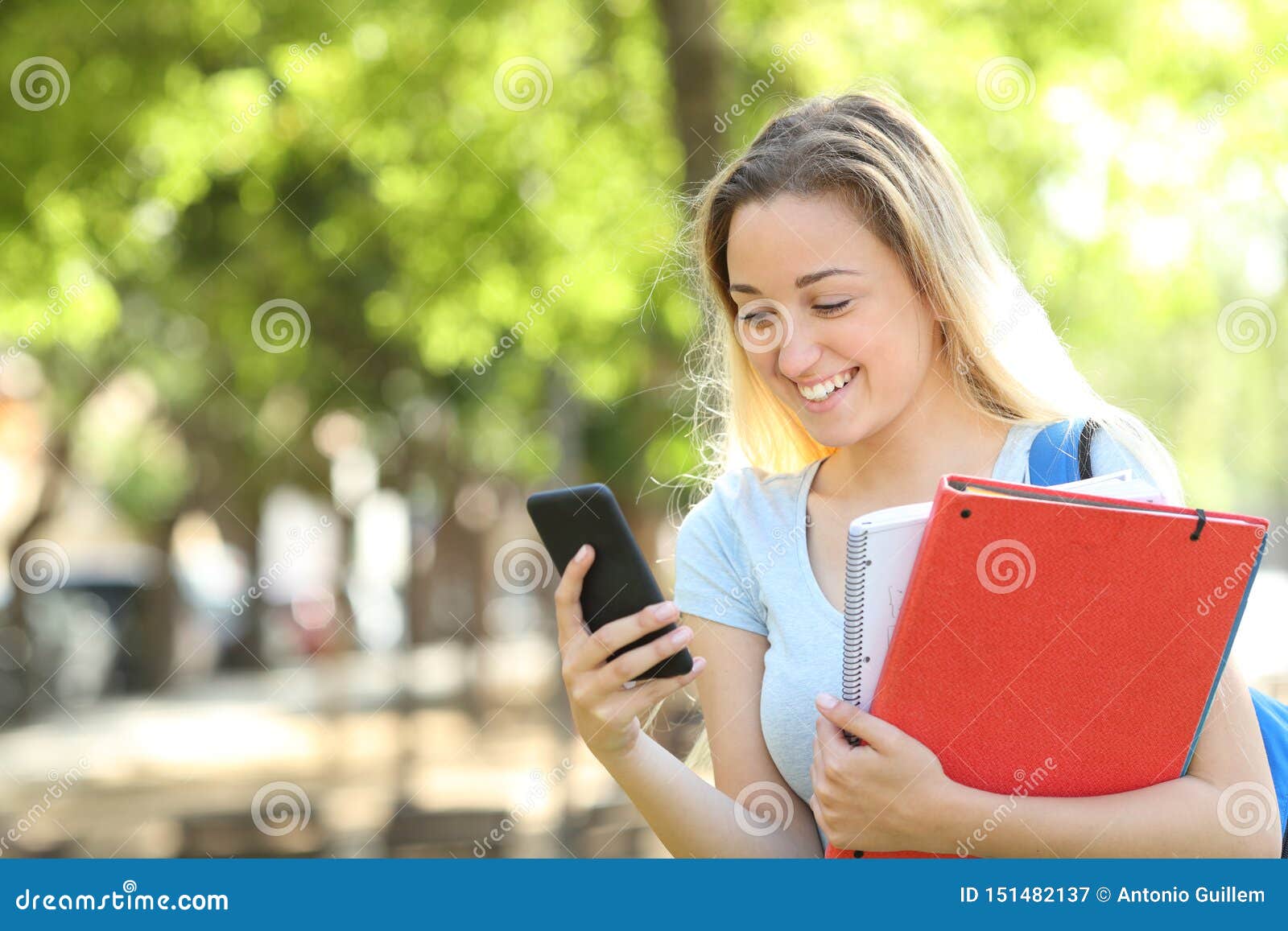 Happy Student in a Park Using Smart Phone Stock Image - Image of ...