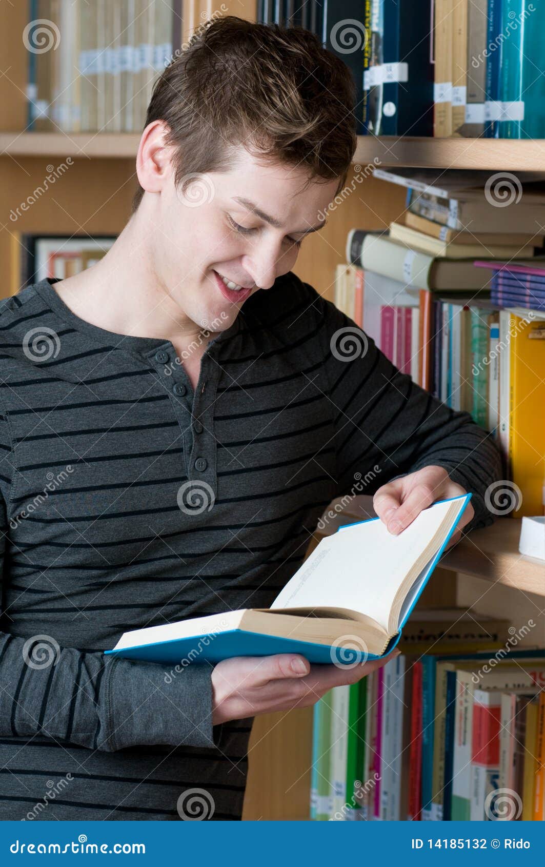 Happy Student Reading Book in a Library Stock Photo - Image of ...