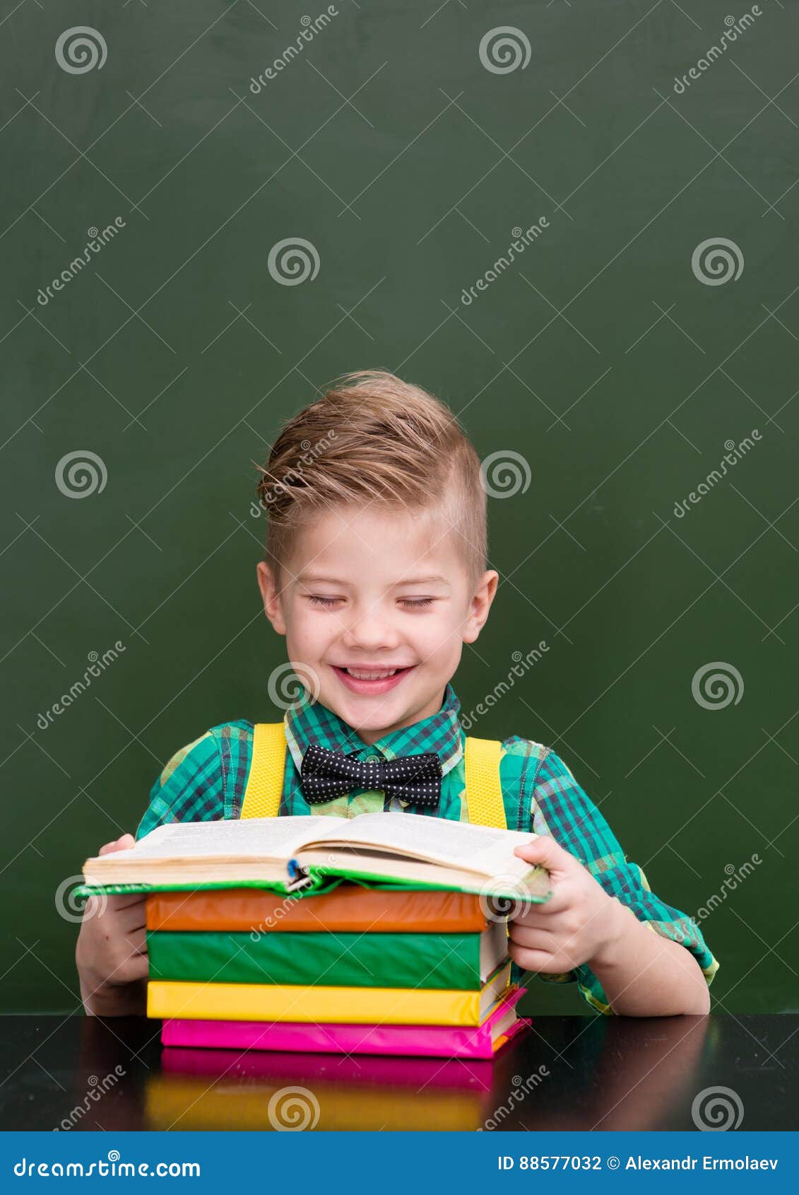 Happy Student Reading a Book Near Empty Green Chalkboard Stock Photo ...