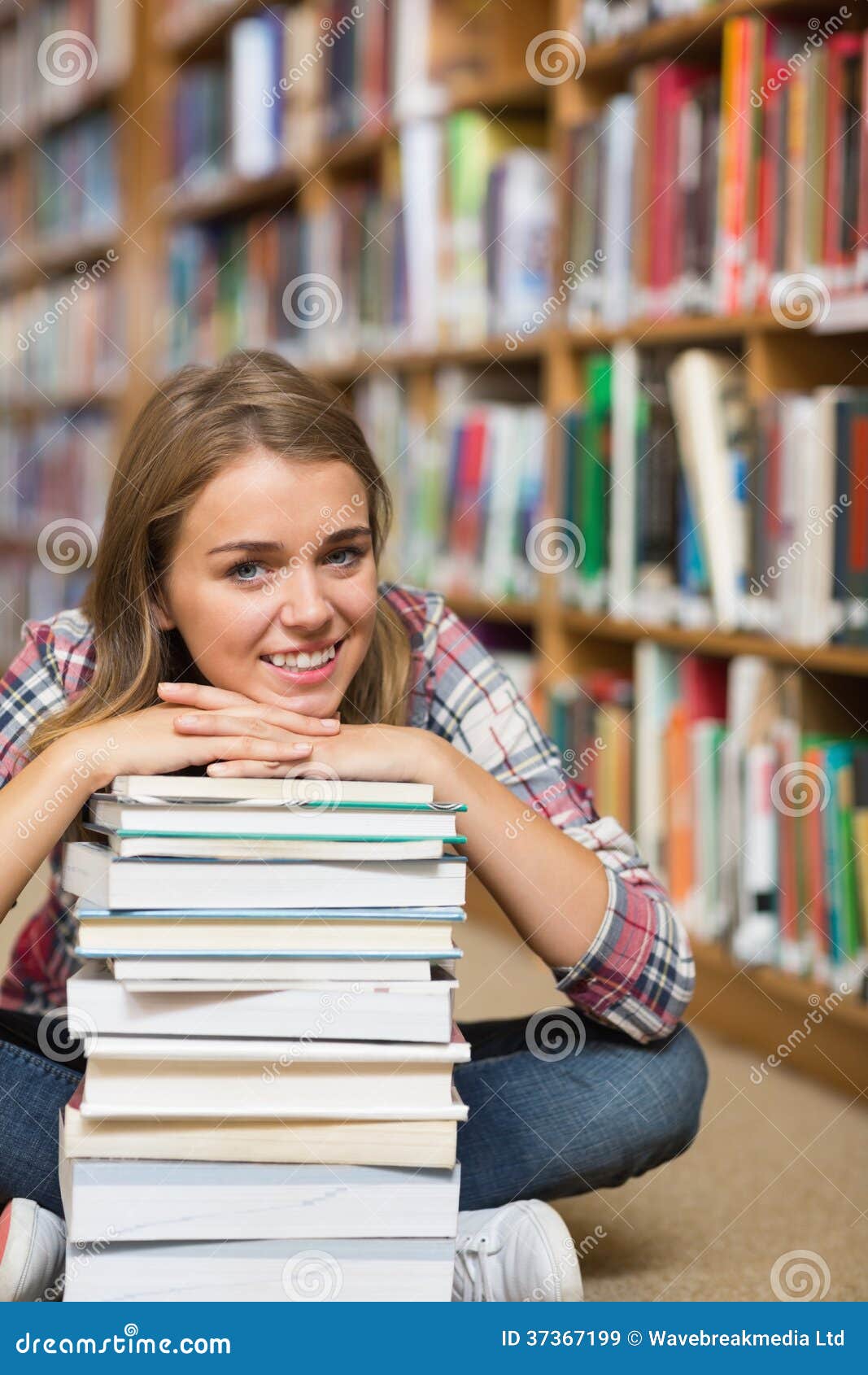 Happy Student Sitting on Library Floor Leaning on Pile of Books Stock ...