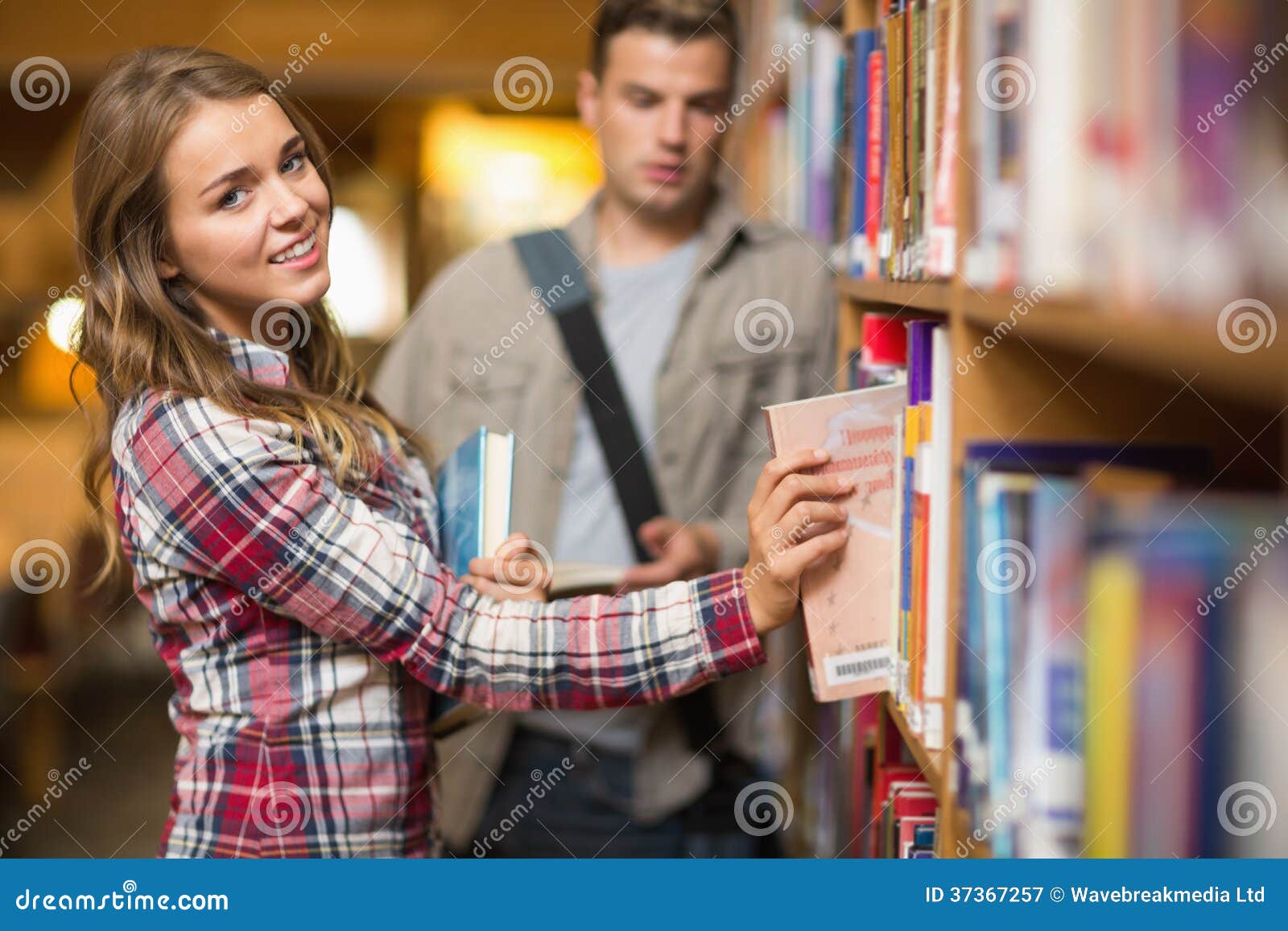 Happy Student Taking Book from Shelf in Library Stock Image - Image of ...