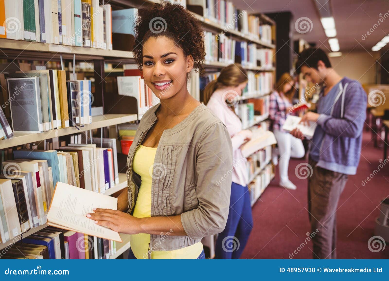 Happy Student Taking Book from Shelf Stock Photo - Image of school ...