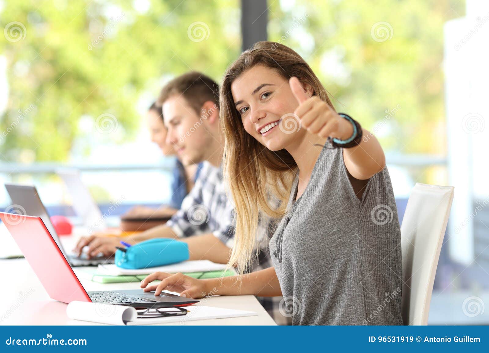 Happy Student with Thumbs Up in a Classroom Stock Image - Image of ...
