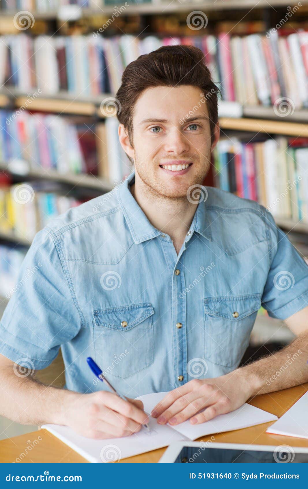 Happy Student Writing To Notebook in Library Stock Photo - Image of ...