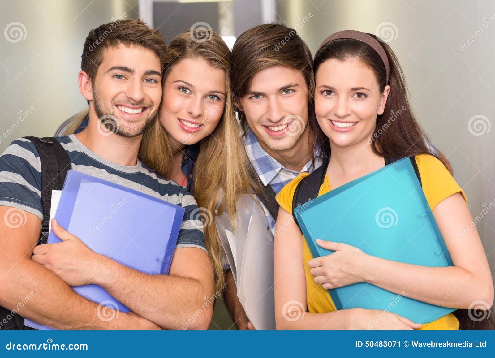 Happy Students Holding Folders at College Corridor Stock Image - Image ...