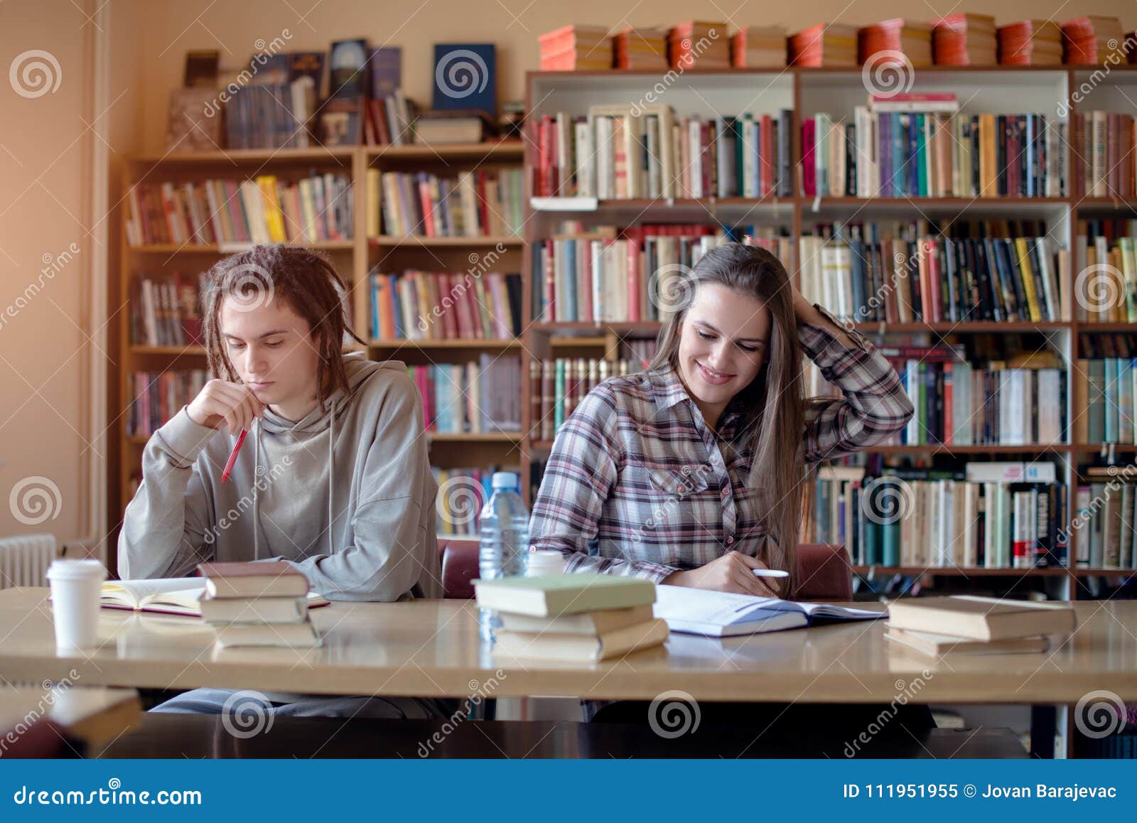 Happy students in library. stock image. Image of laughing - 111951955