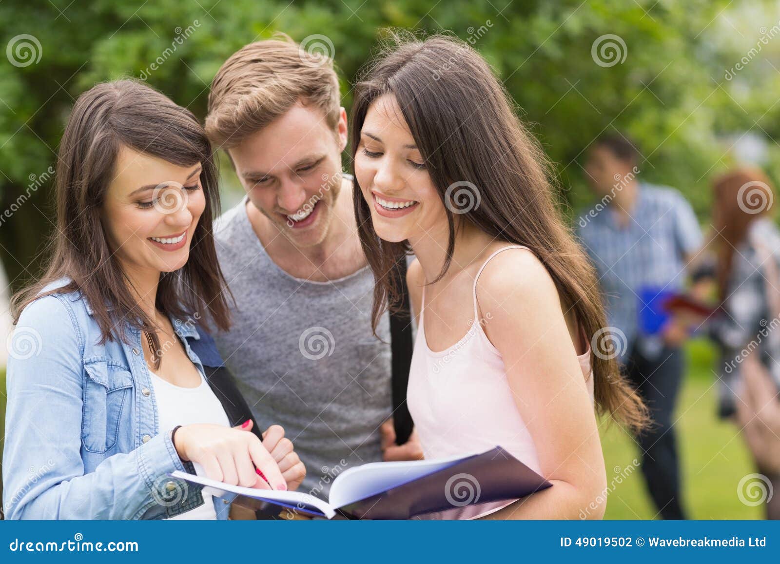 Happy Students Reading from Notepad Stock Photo - Image of three ...